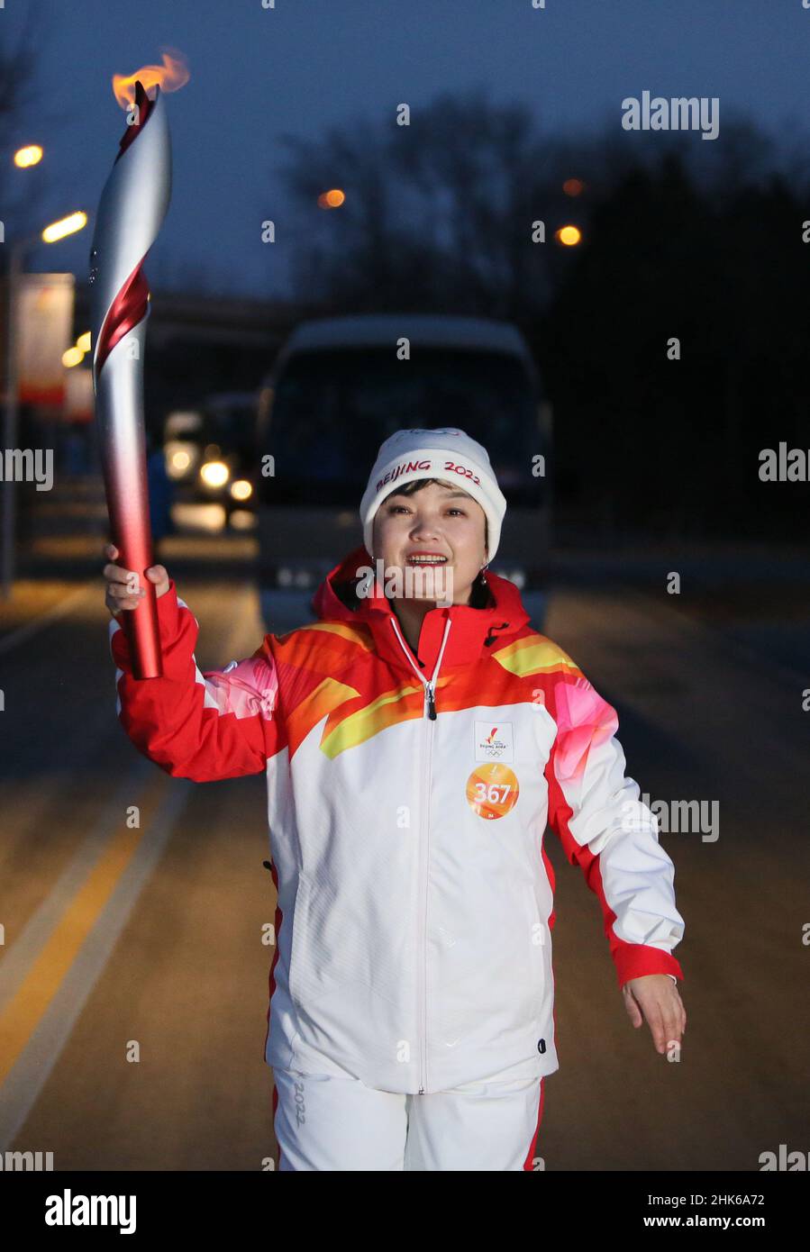 Beijing, China. 2nd Feb, 2022. Torch bearer Zhang Ying runs with the torch during the Beijing ...