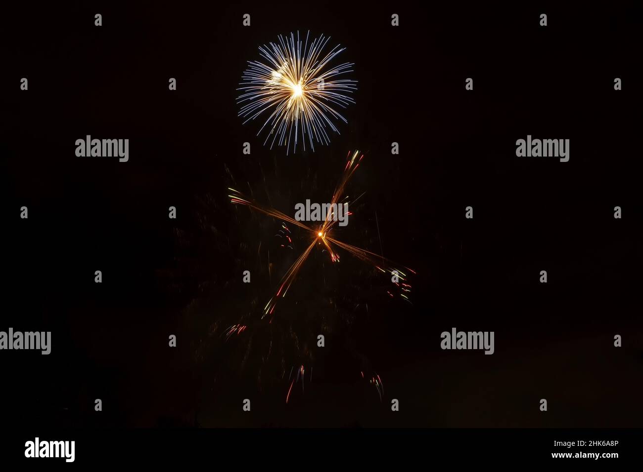 Night light show. Bright rays of fiery fireworks on black background of ...