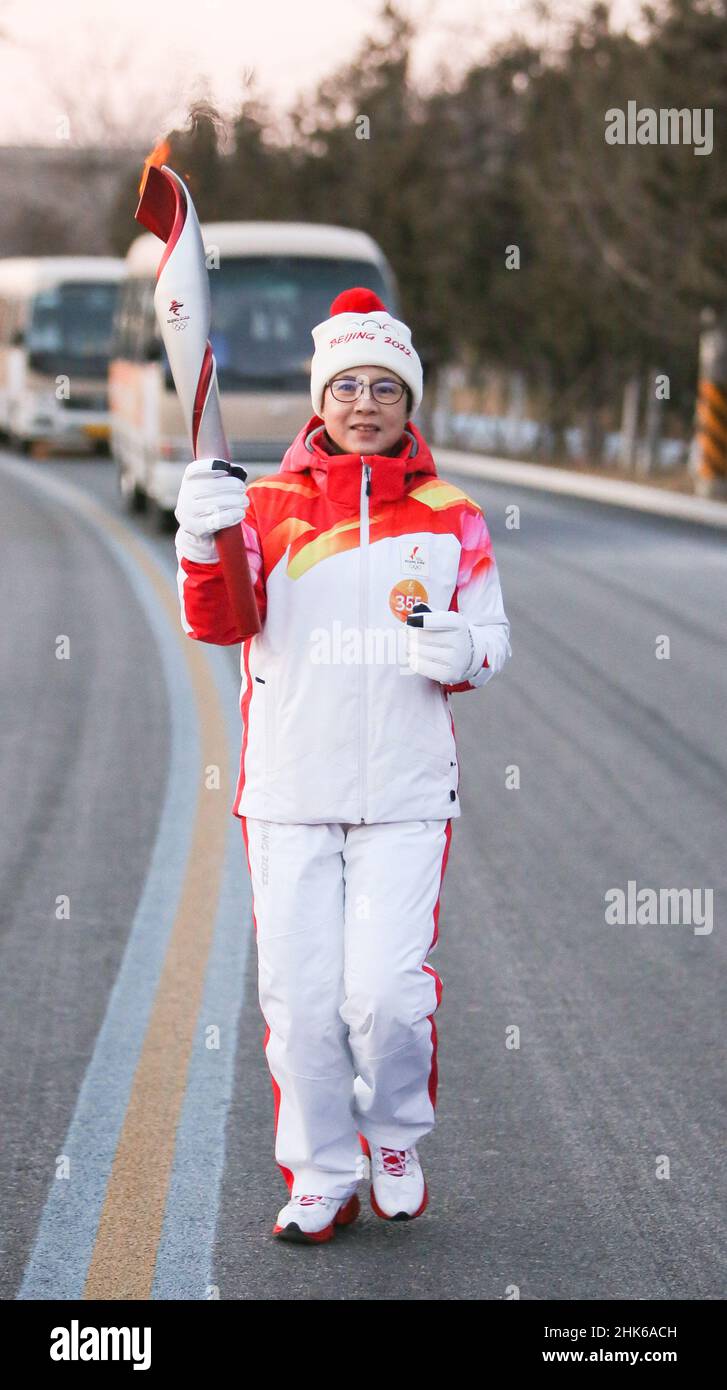 Beijing, China. 2nd Feb, 2022. Torch bearer Zhang Bo runs with the torch during the Beijing 2022 ...
