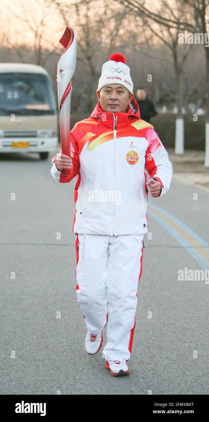 Beijing, China. 2nd Feb, 2022. Torch bearer Wang Yunfeng runs with the ...