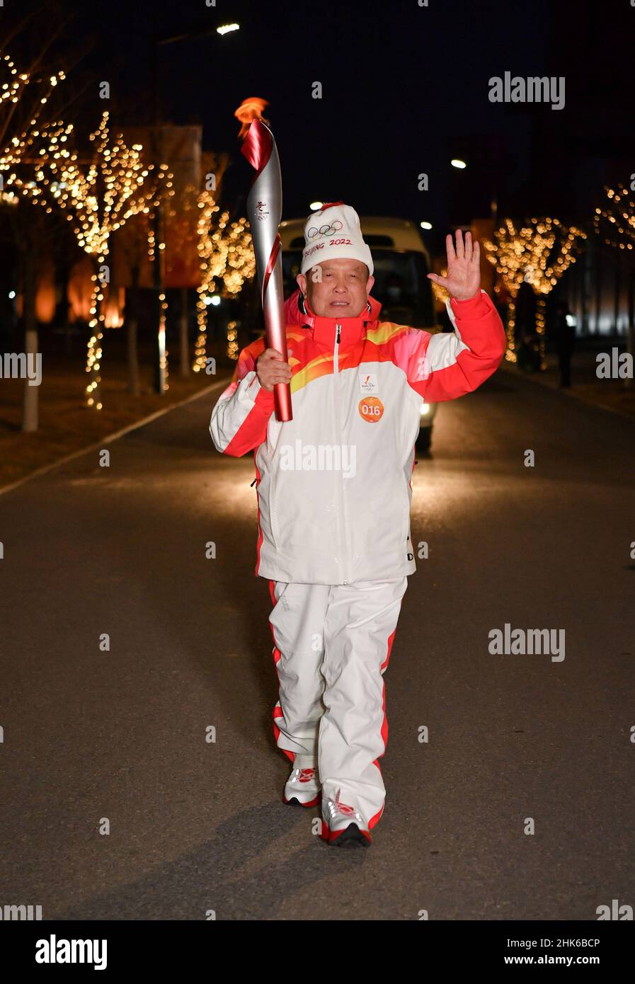 Beijing, China. 2nd Feb, 2022. Torch bearer Li Yu runs with the torch during the Beijing 2022 ...