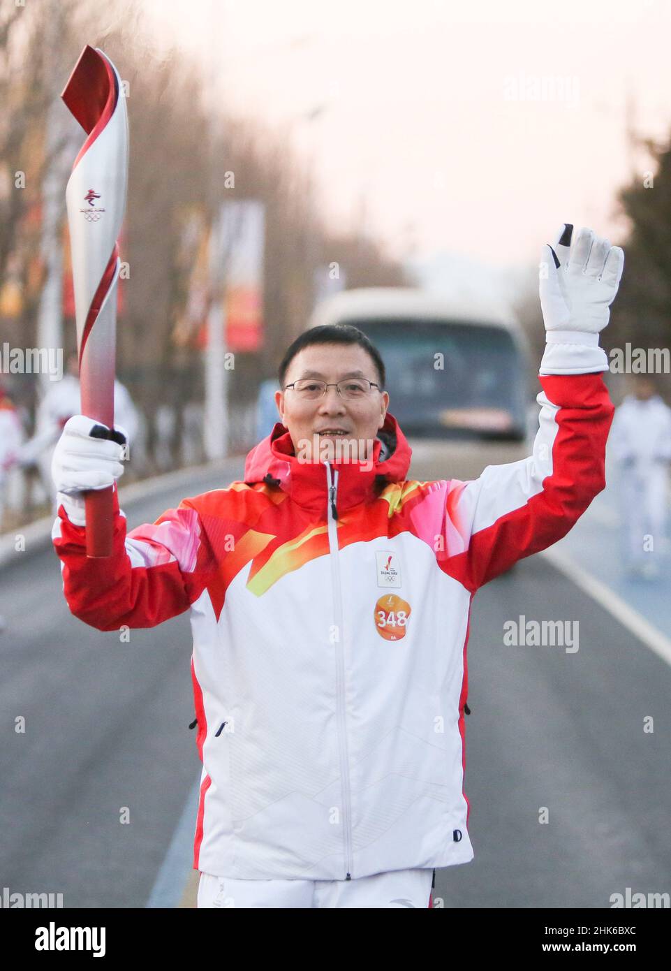 Beijing, China. 2nd Feb, 2022. Torch bearer Yang Weizhong runs with the torch during the Beijing ...