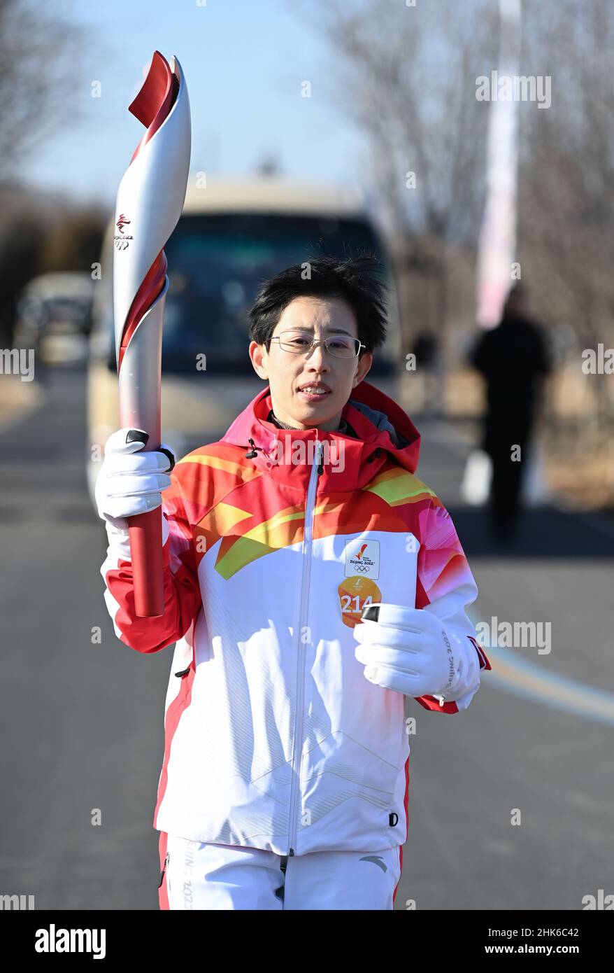 Beijing, China. 2nd Feb, 2022. Torch bearer Liu Dongmei runs with the torch during the Beijing ...