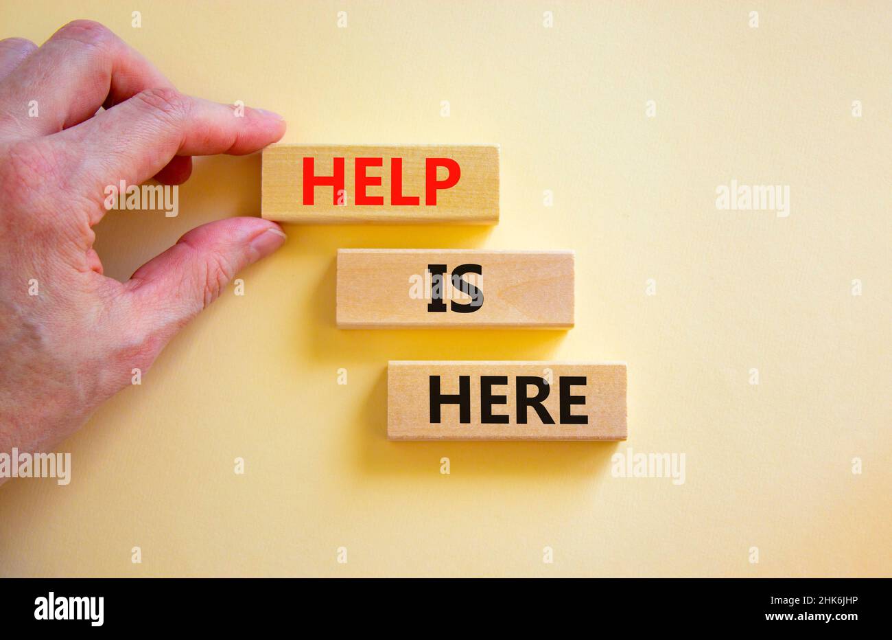 Help is here and support symbol. Concept words Help is here on wooden ...
