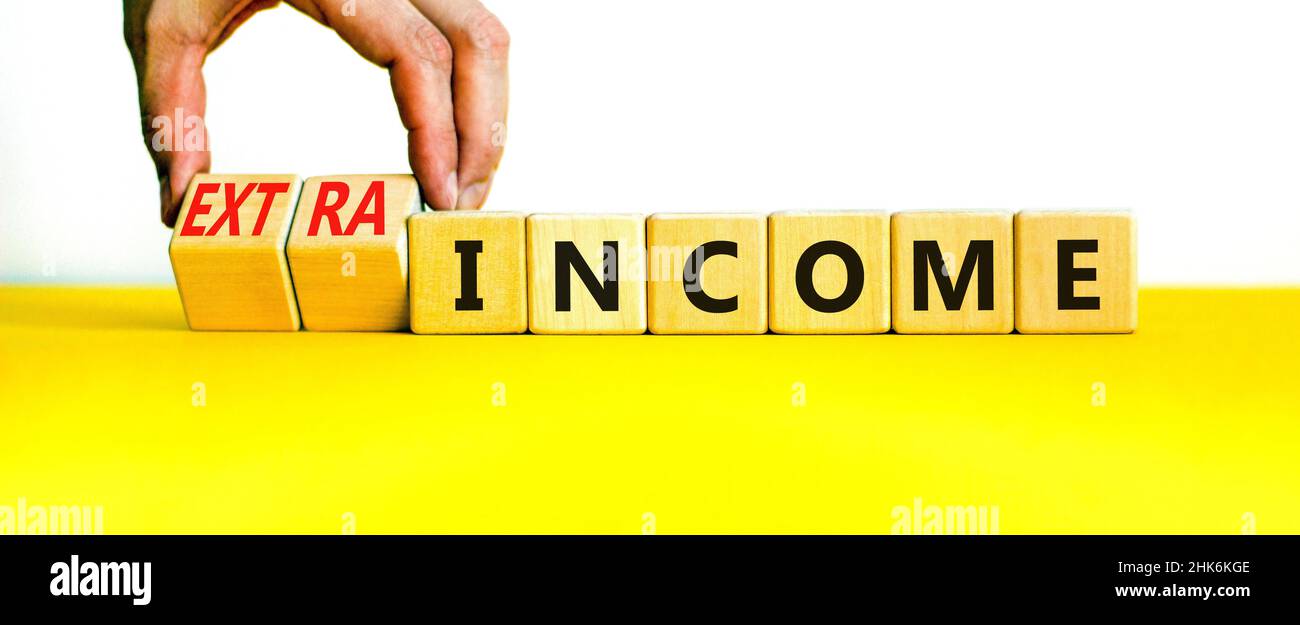 Extra income symbol. Businessman turns wooden cubes and changes concept ...