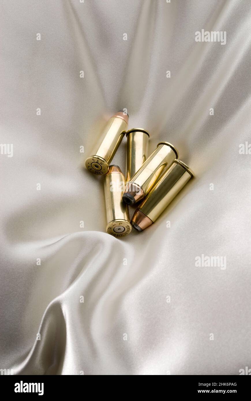 Group of bullets laying on satin pillow Stock Photo - Alamy
