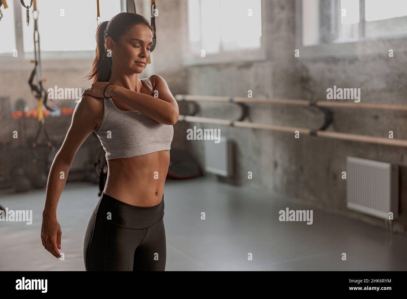 Beautiful female athlete exercising in fitness club Stock Photo - Alamy