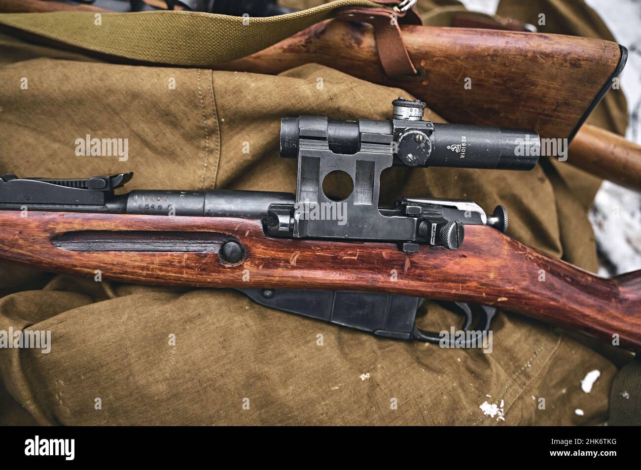 part of a rifle with a sniper scope on a canvas Stock Photo - Alamy