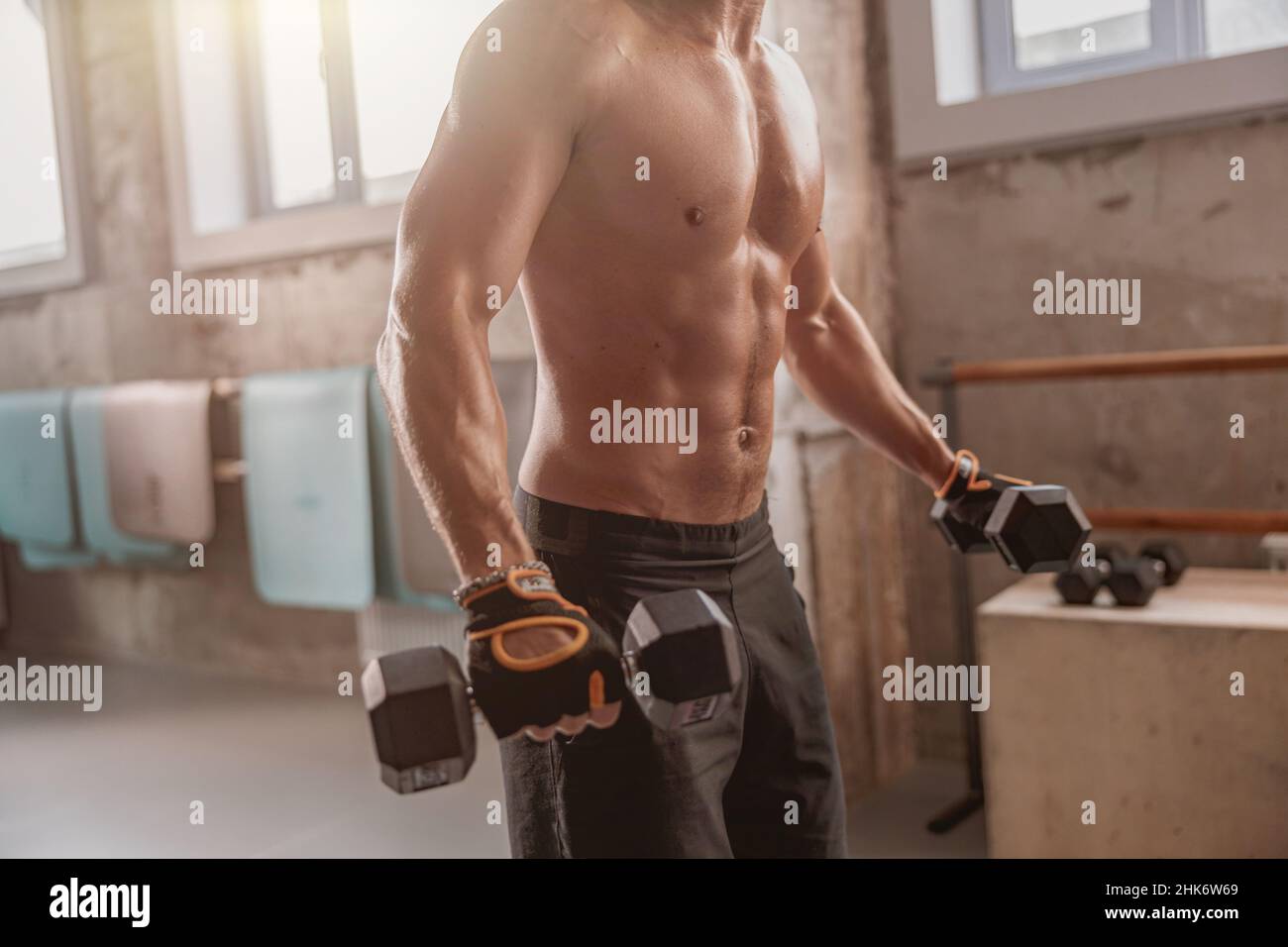 Muscular man working out in the fitness club Stock Photo - Alamy