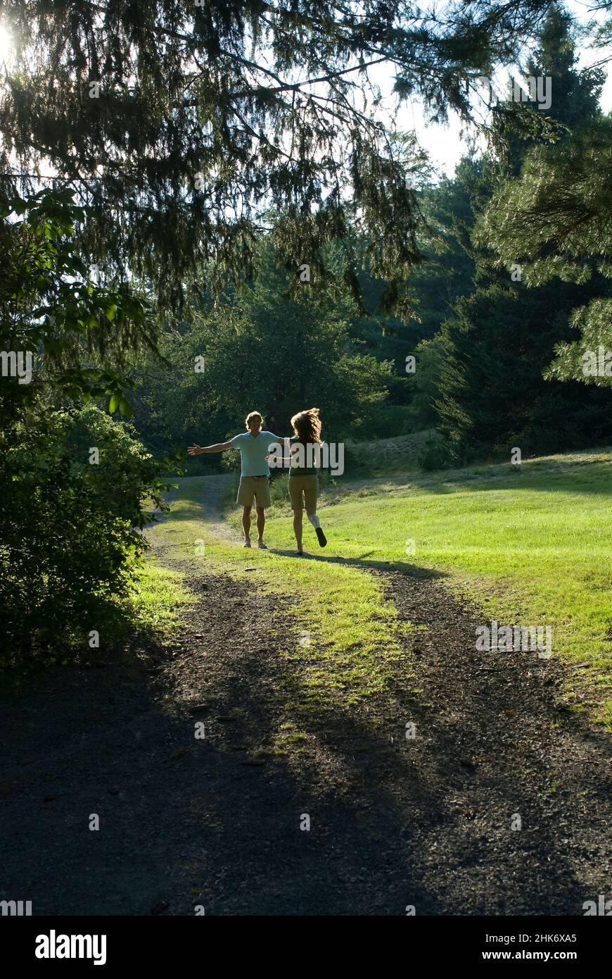 Young woman running into a man's open arms Stock Photo - Alamy