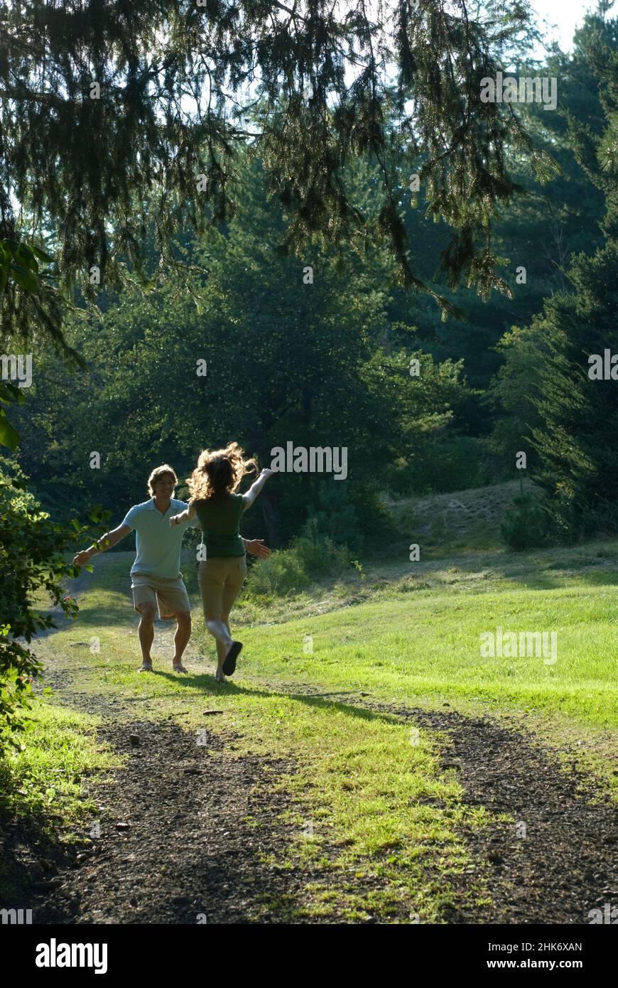 Young woman running into a man's open arms Stock Photo - Alamy