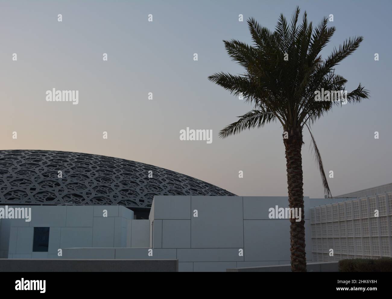 UAE Dubai - palm tree in the front of Louvre Dubai in the sunset Stock ...