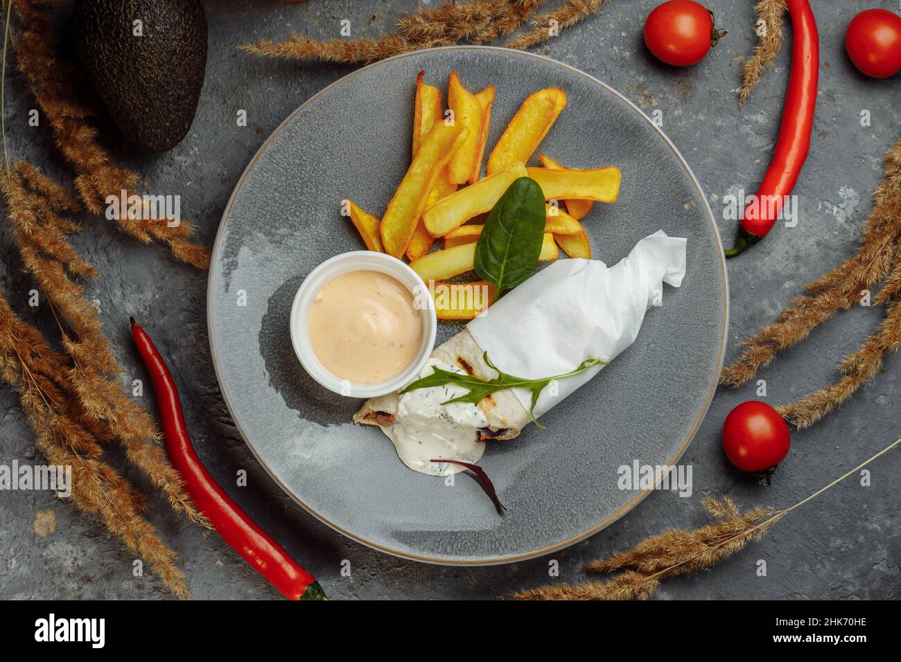 Shawarma Sandwich with French Fires and Salt Grinder on Dark Background ...