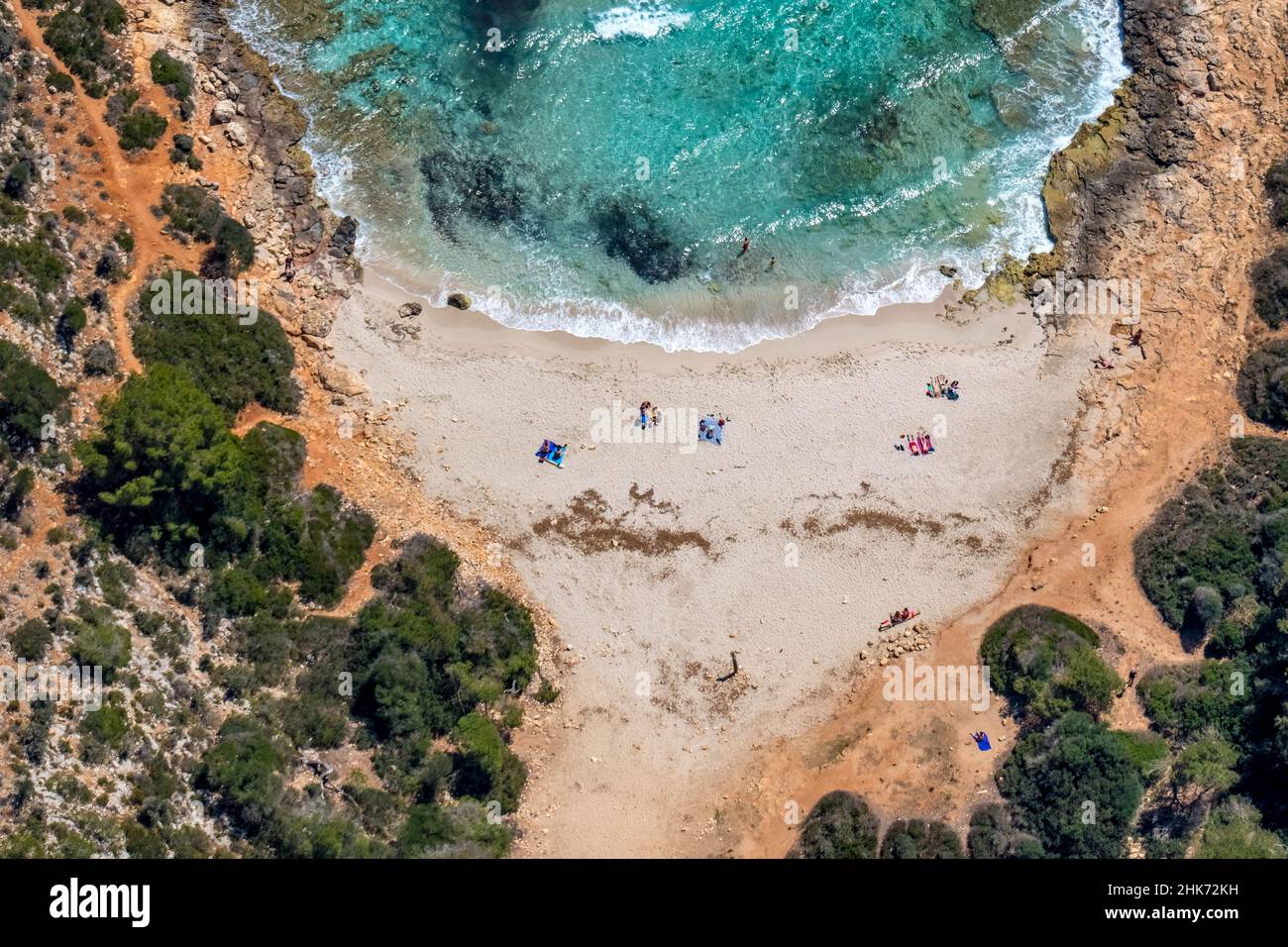 Bathers at the sandy beach in the bay cala varques hi-res stock ...
