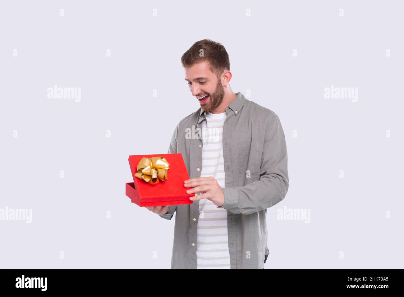Man Holding Present Watching Whats inside. Man Holding Gift. Surprise ...