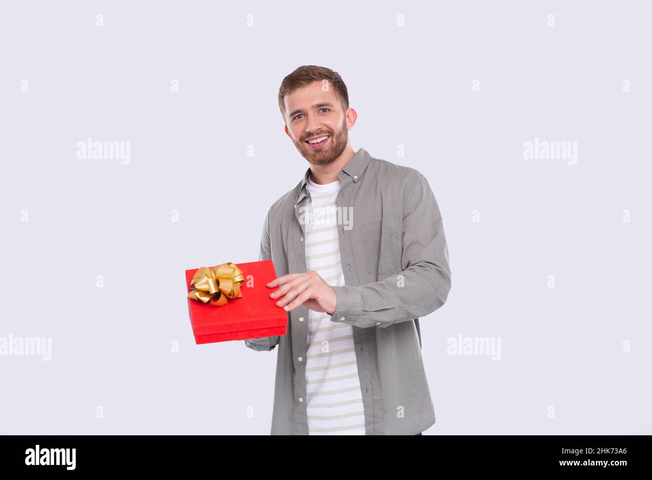 Man Holding Present Watching Whats inside. Man Holding Gift. Surprise ...