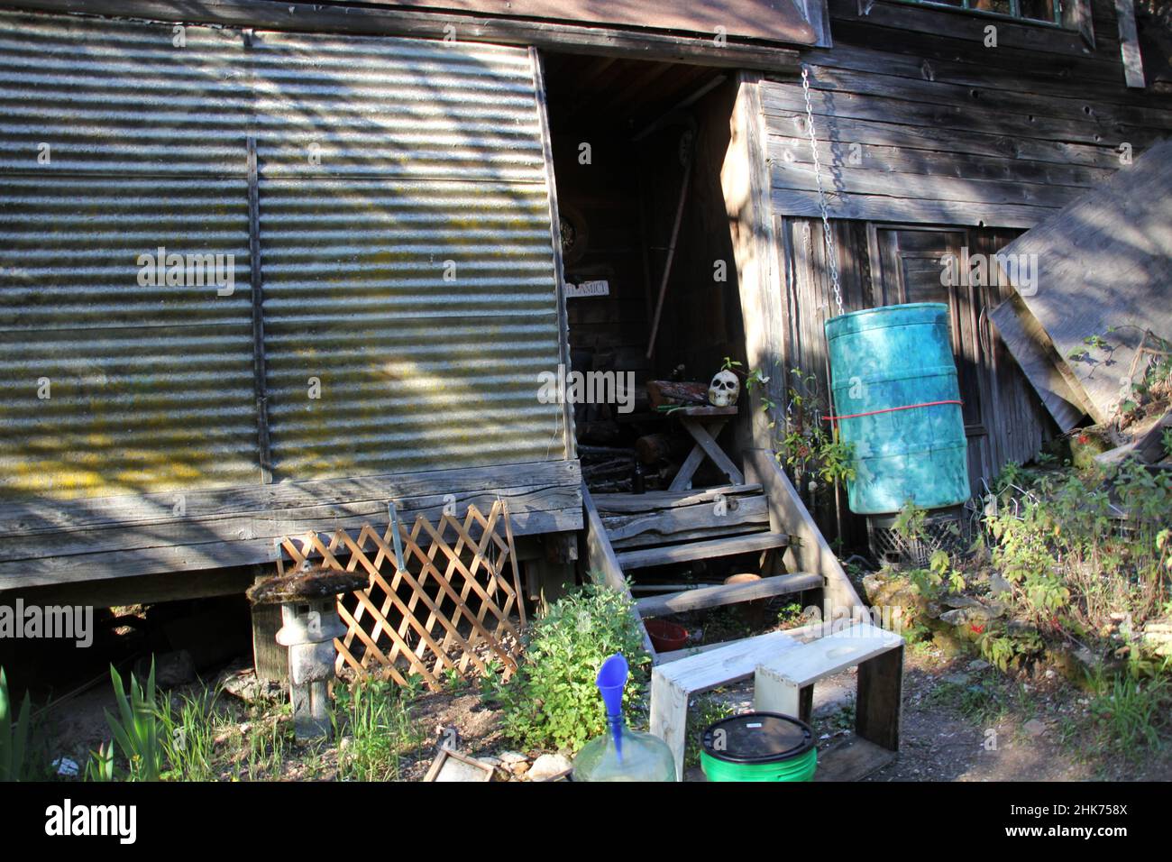 Mysterious-looking tiny wooden house with small stairs and a skull ...