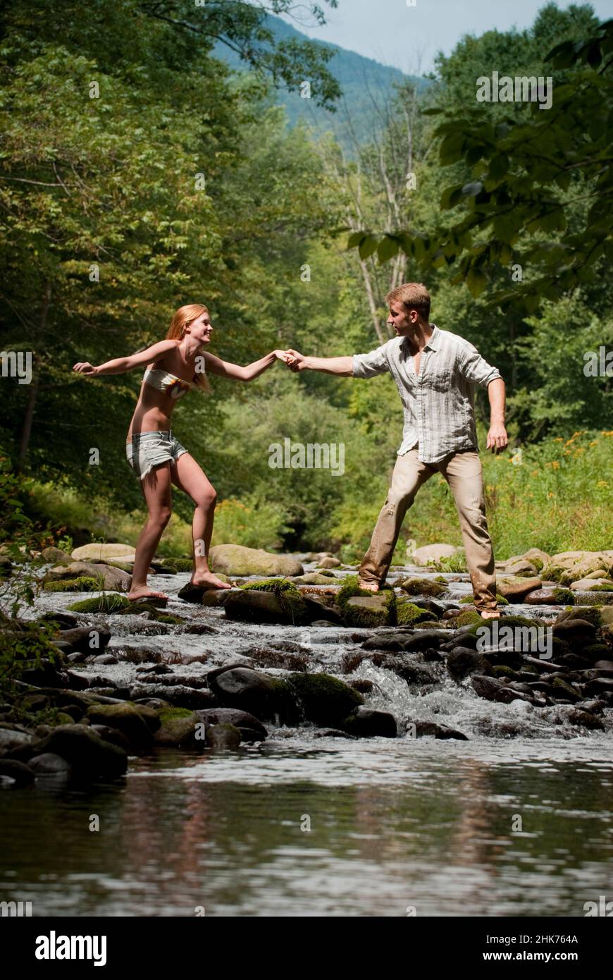 Beautiful young couple helping other hi-res stock photography and ...