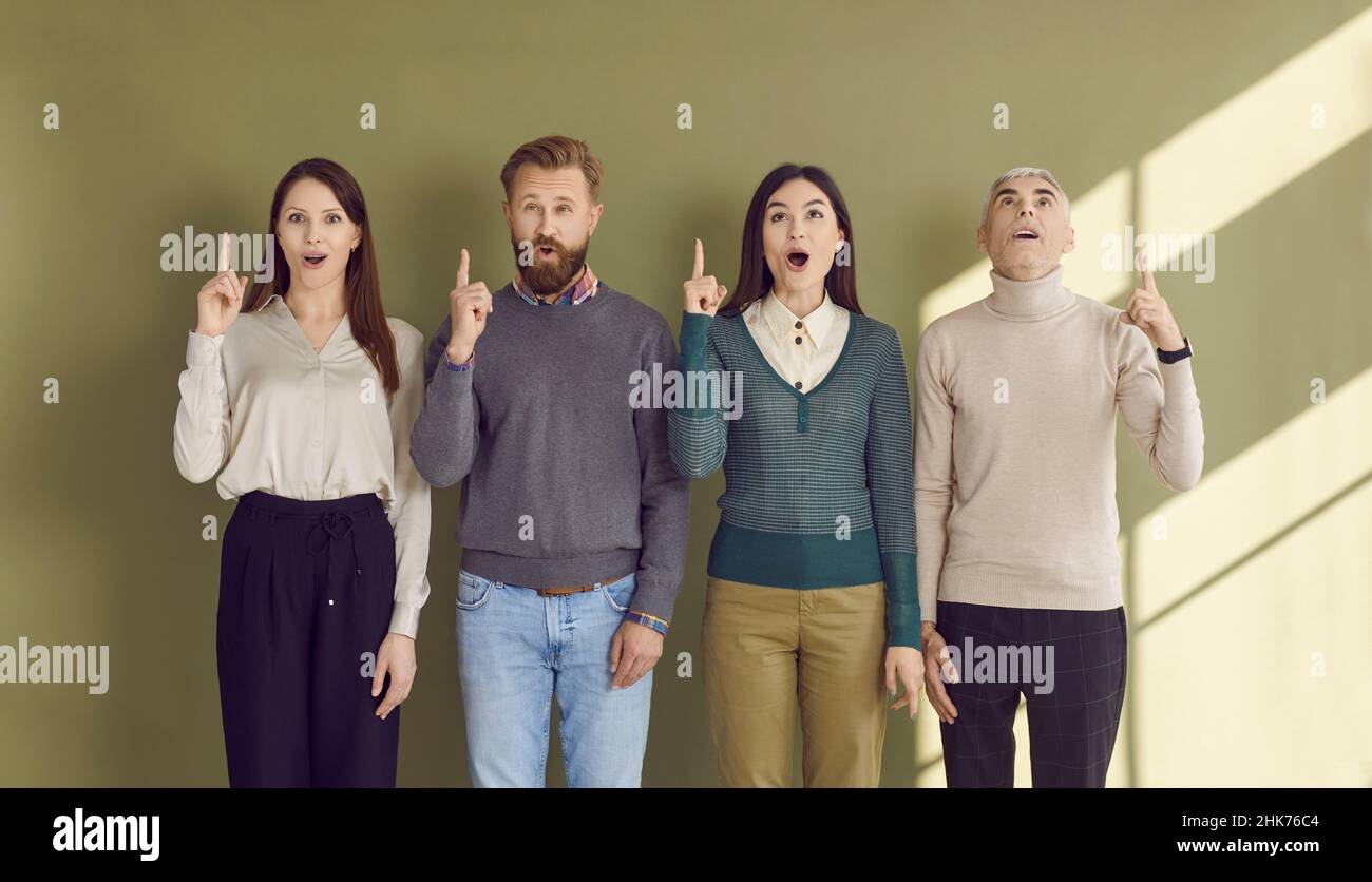 Group of four people pointing their fingers up when they think of a ...