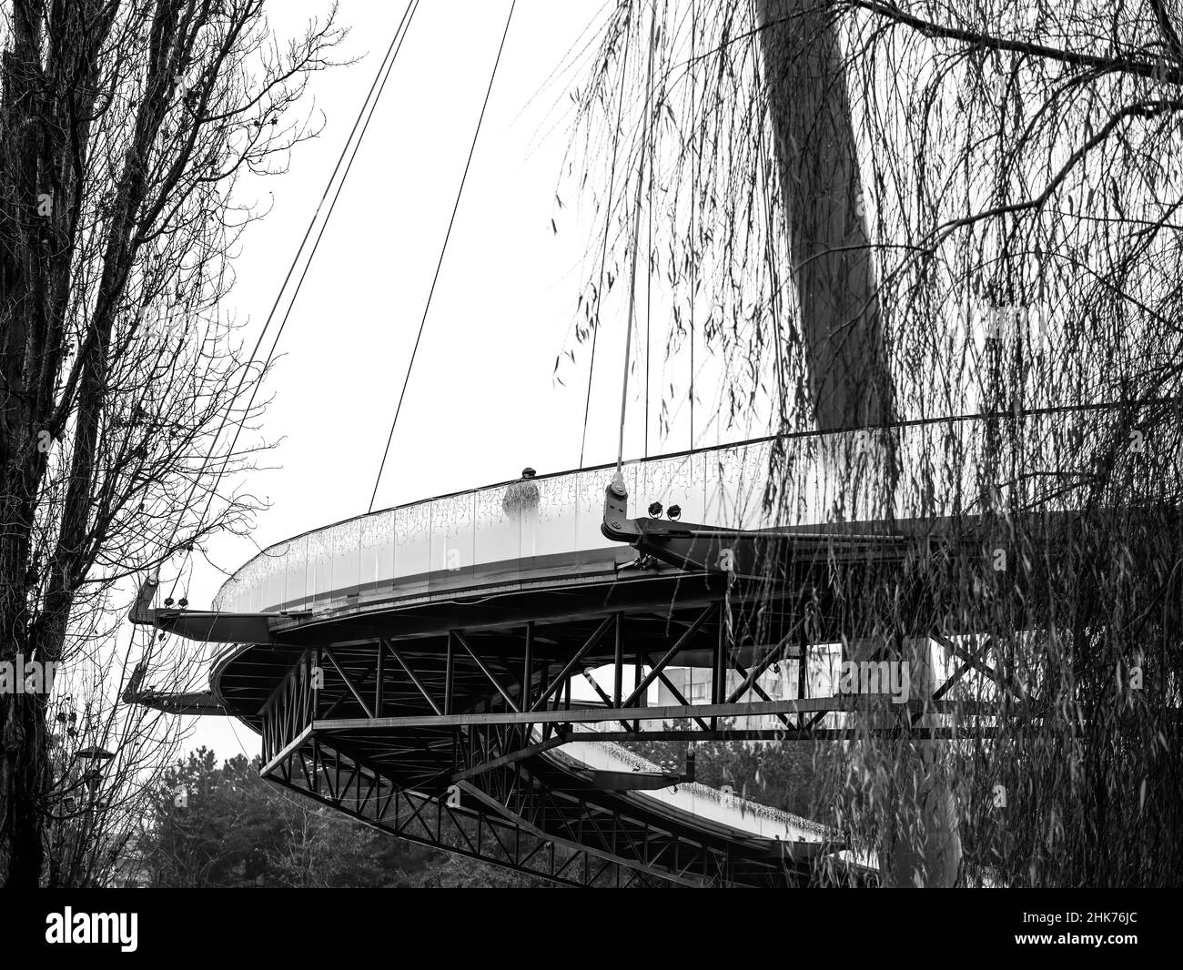 Man walking on a bridge in the park. Monochrome landscape in Moghioros ...