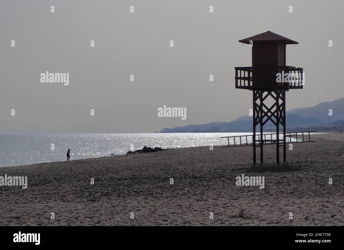 Watchtower on the beach against the light, bathing tower, lookout tower ...