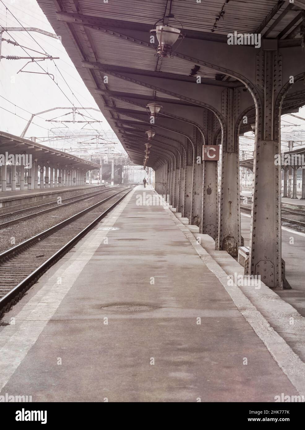 Lonely moody scene with an empty train station or railway platform on a ...