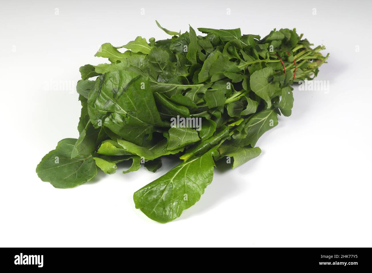 Bundle of green arugula isolated on white background Stock Photo - Alamy