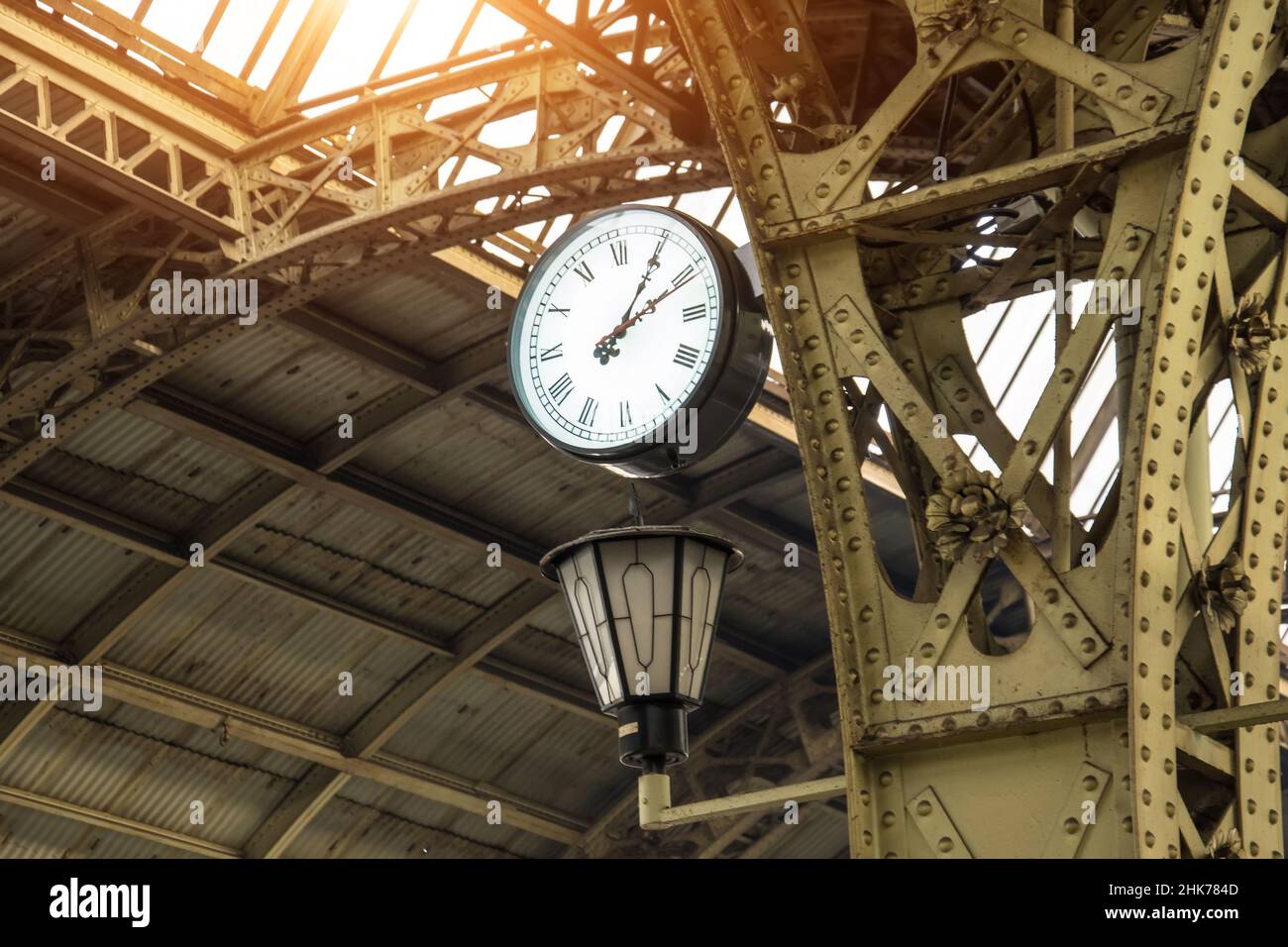 Vintage clock and lantern on train station with building roof Stock ...
