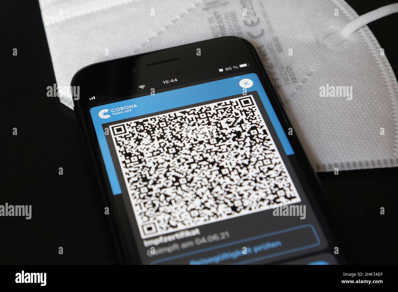 FFP2 mask and iPhone with Corona warning app with QR code for ...