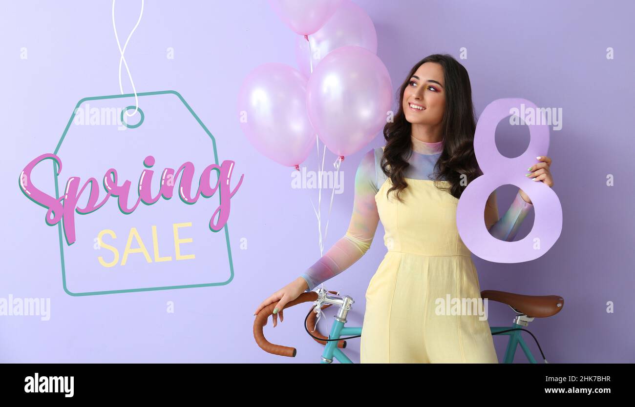 Beautiful woman with paper figure 8 and bicycle on color background ...