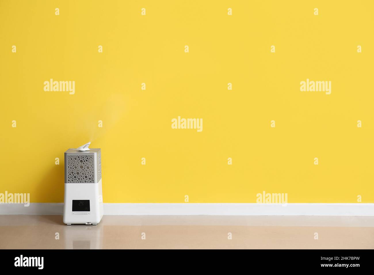 Modern humidifier near color wall Stock Photo - Alamy