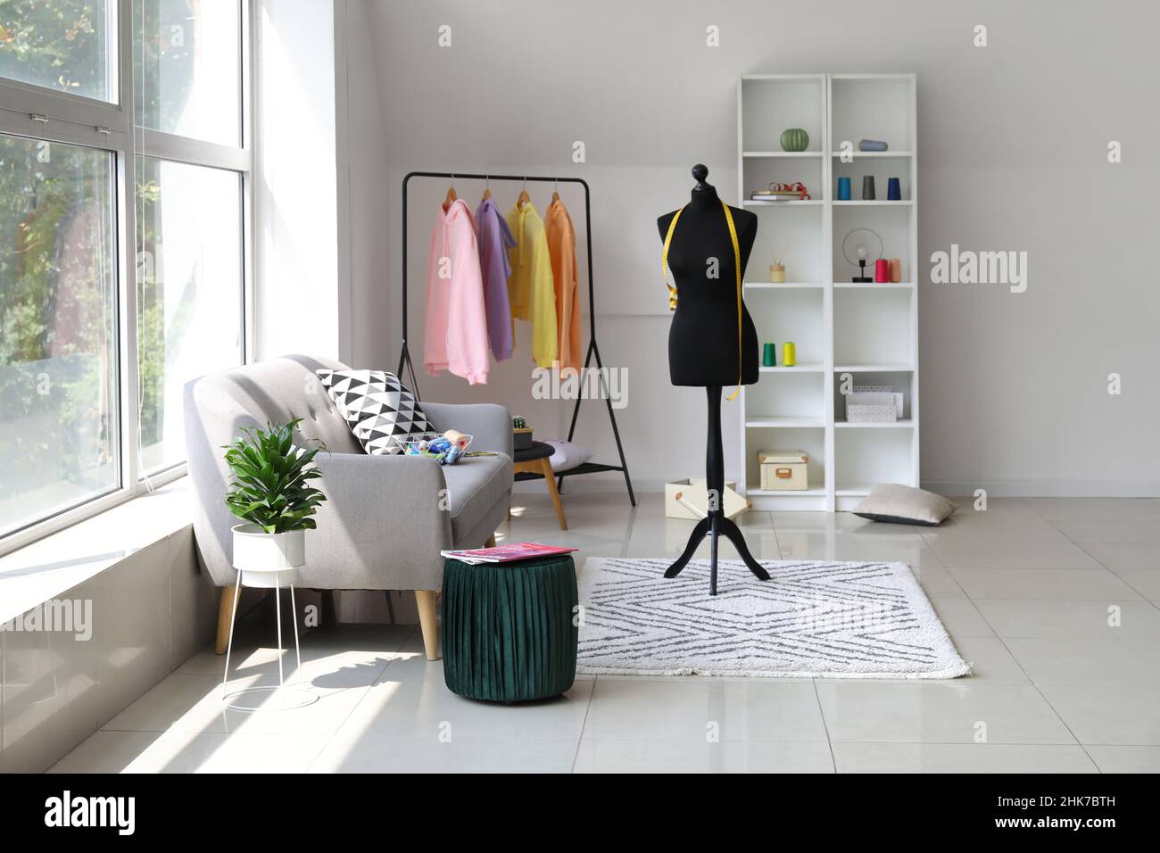 Interior of modern room with mannequin, rack and hoodies Stock Photo ...