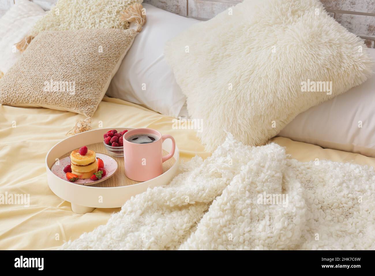 Tray with breakfast on comfortable bed with pillows and plaid Stock ...