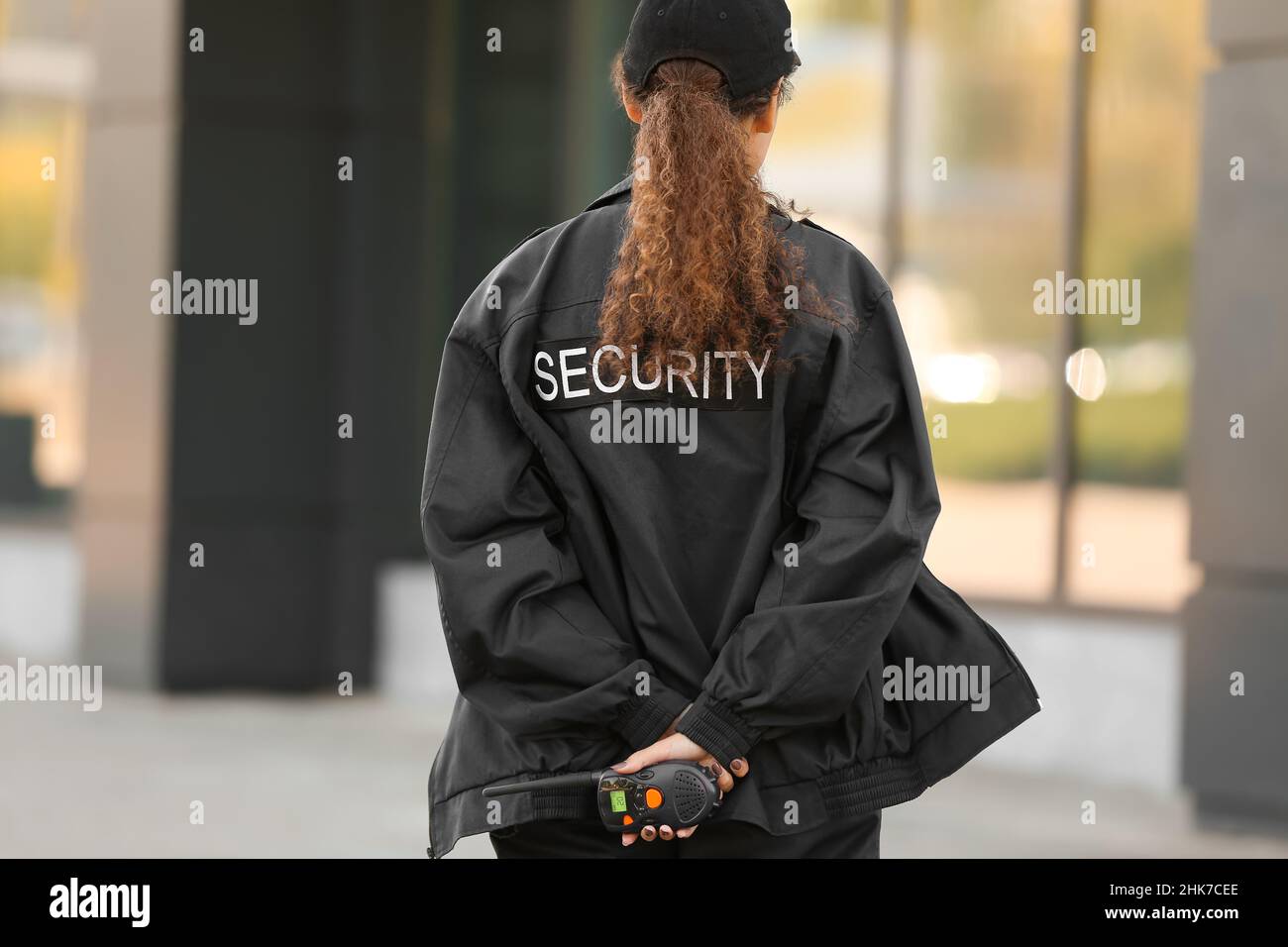 African-American female security guard with radio transmitter near ...