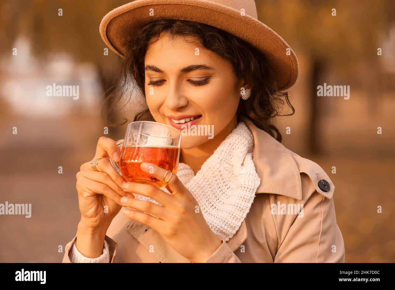 Beautiful woman drinking tea outdoors Stock Photo - Alamy