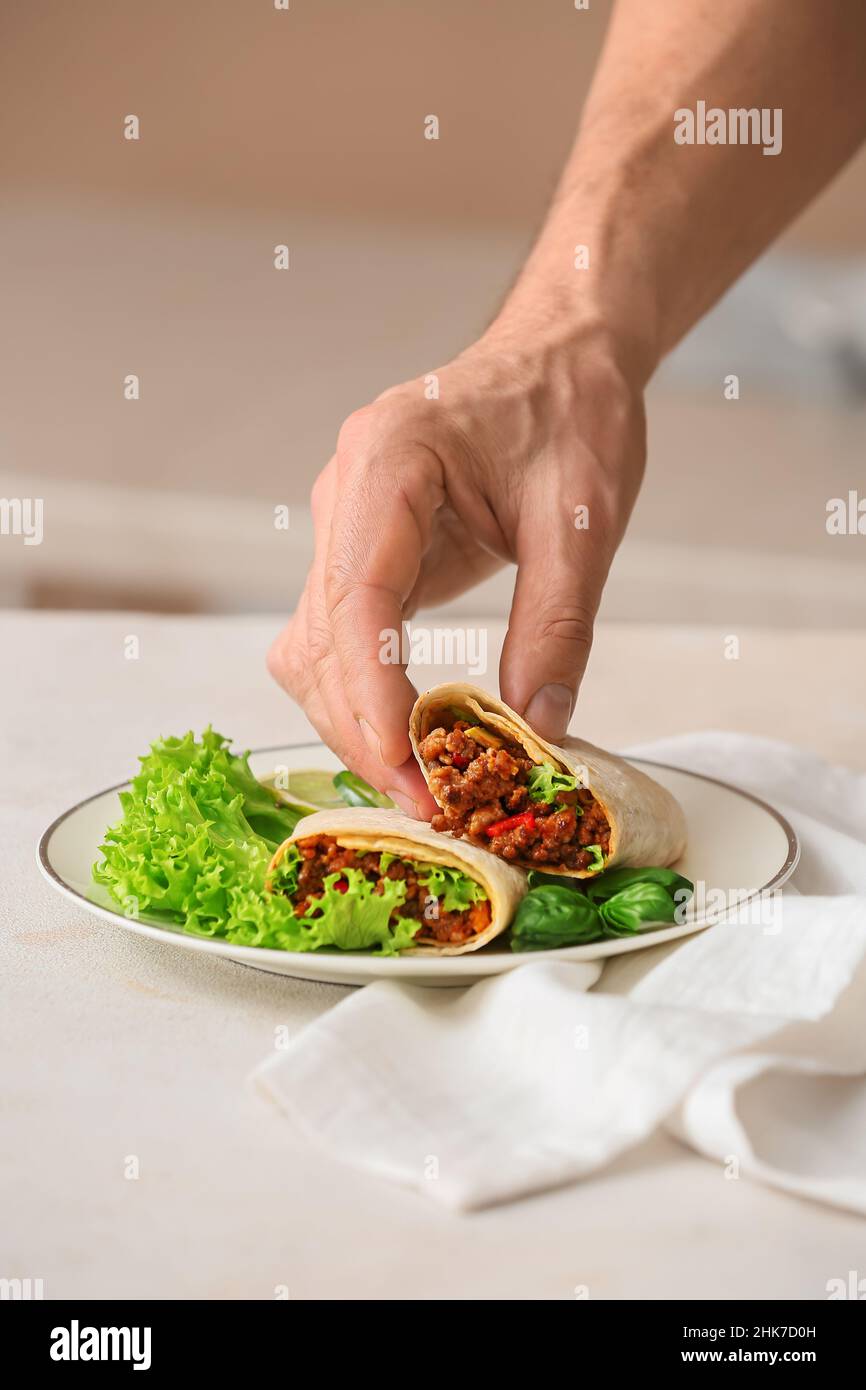 Hand holding mexican street food burrito hi-res stock photography and ...