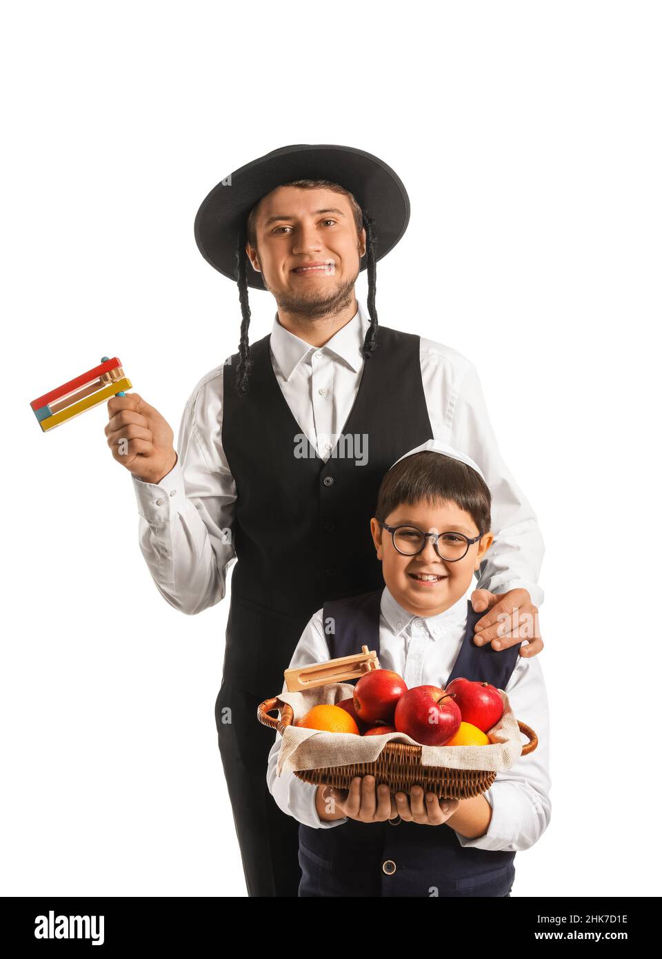 Jewish man and boy with gragger for Purim holiday and fruits in basket ...