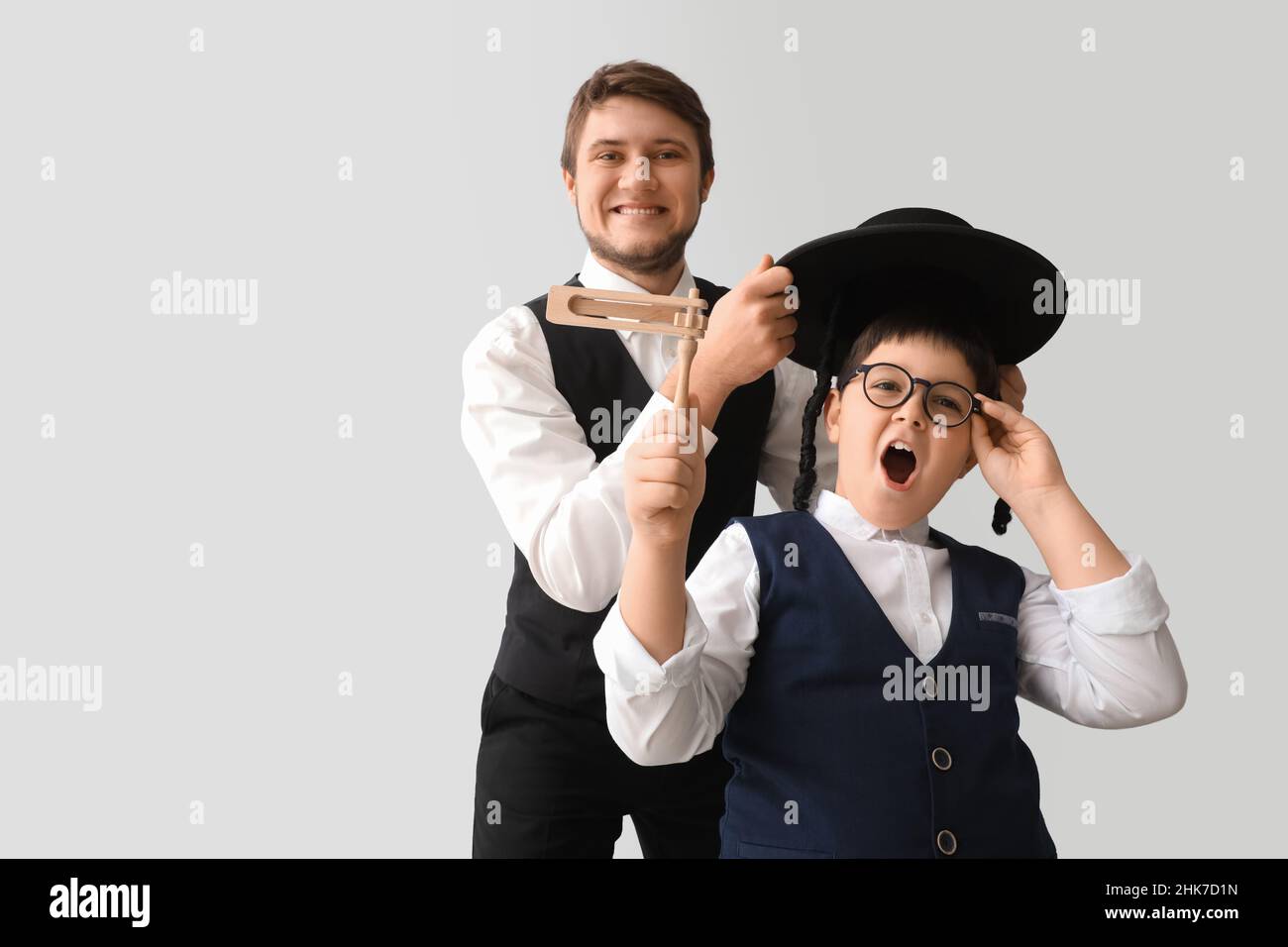 Happy Jewish man and boy in traditional costumes and with gragger for ...