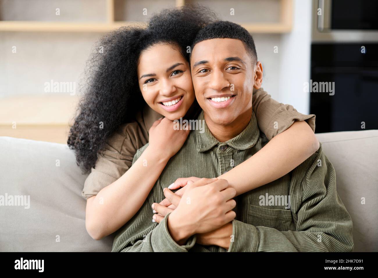 Couple hugging behind sofa hi-res stock photography and images - Alamy