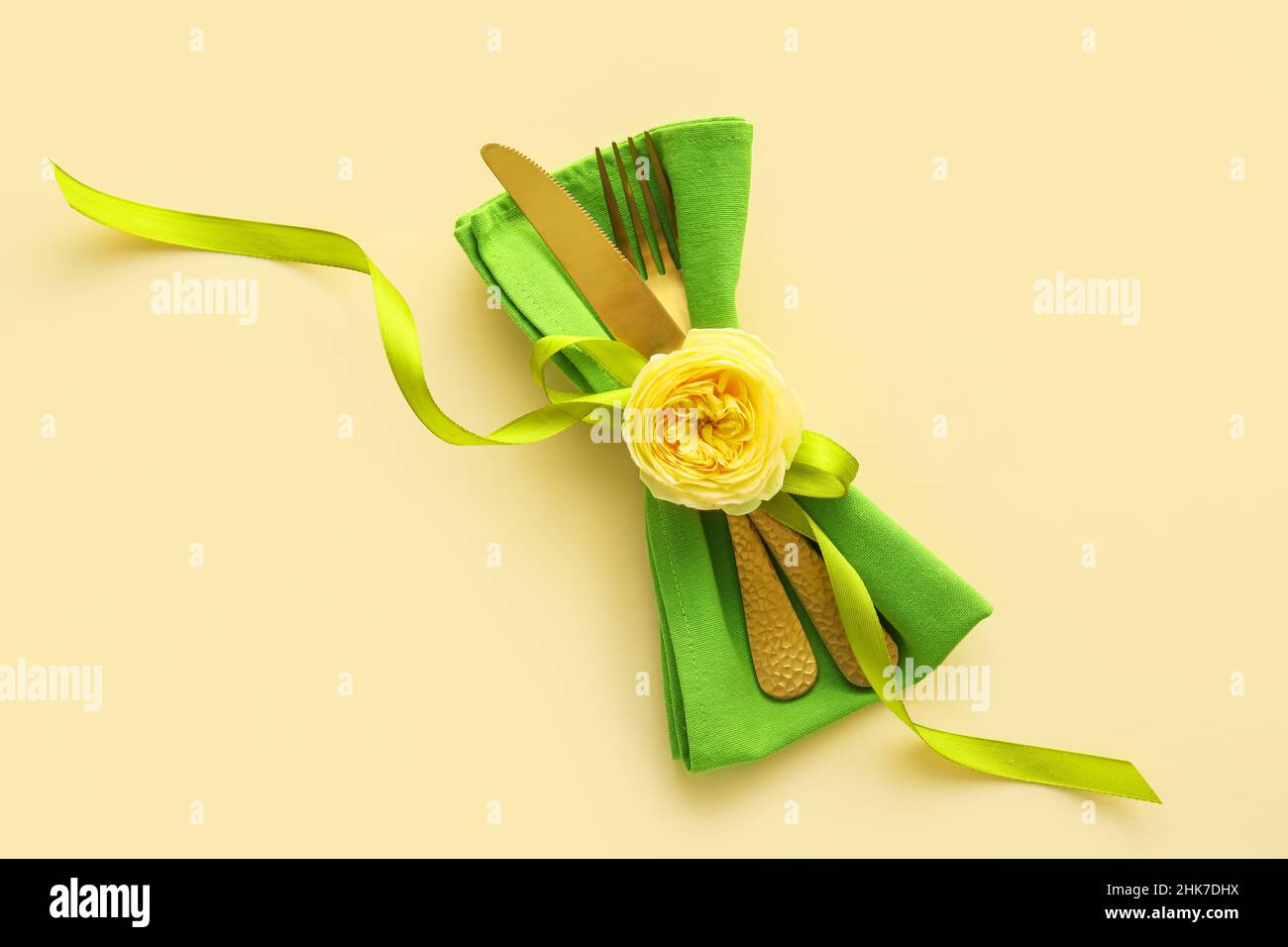 Stylish cutlery with flower on yellow background Stock Photo - Alamy