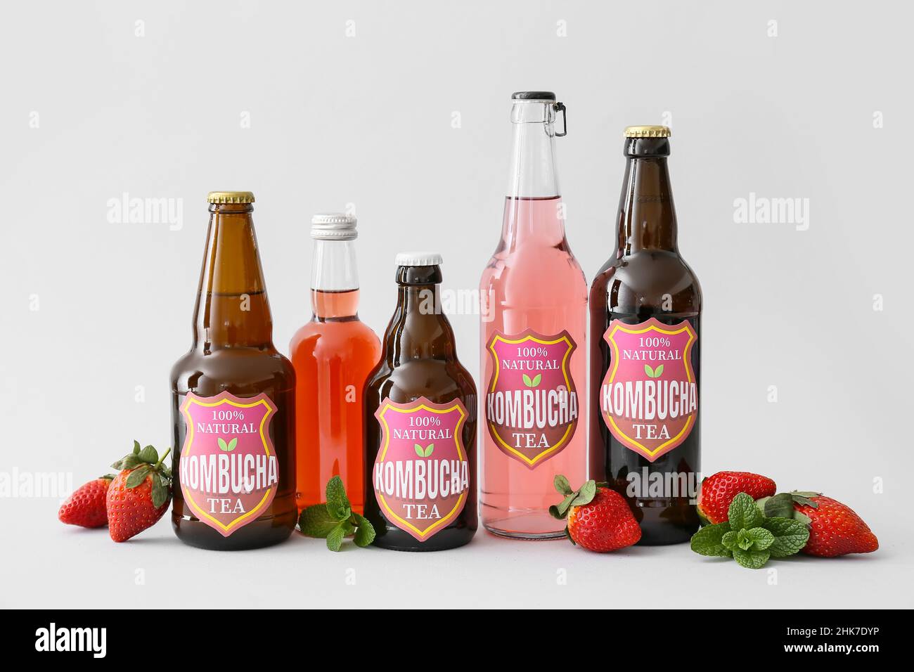 Bottles of fresh strawberry kombucha on light background Stock Photo ...