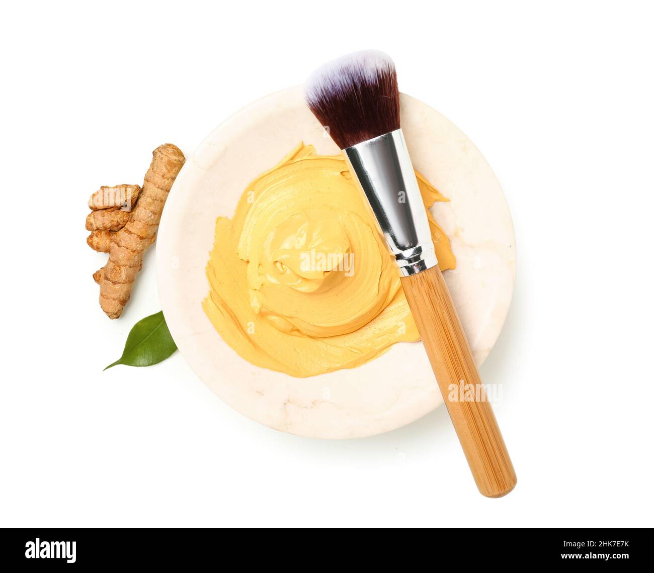 Bowl with turmeric mask and makeup brush on white background Stock ...