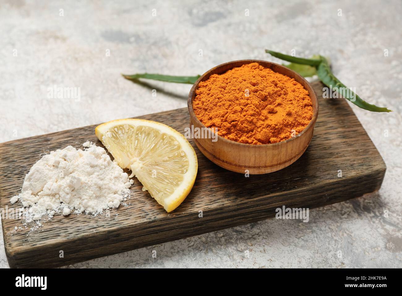 Board with turmeric powder and lemon on light background, closeup Stock ...