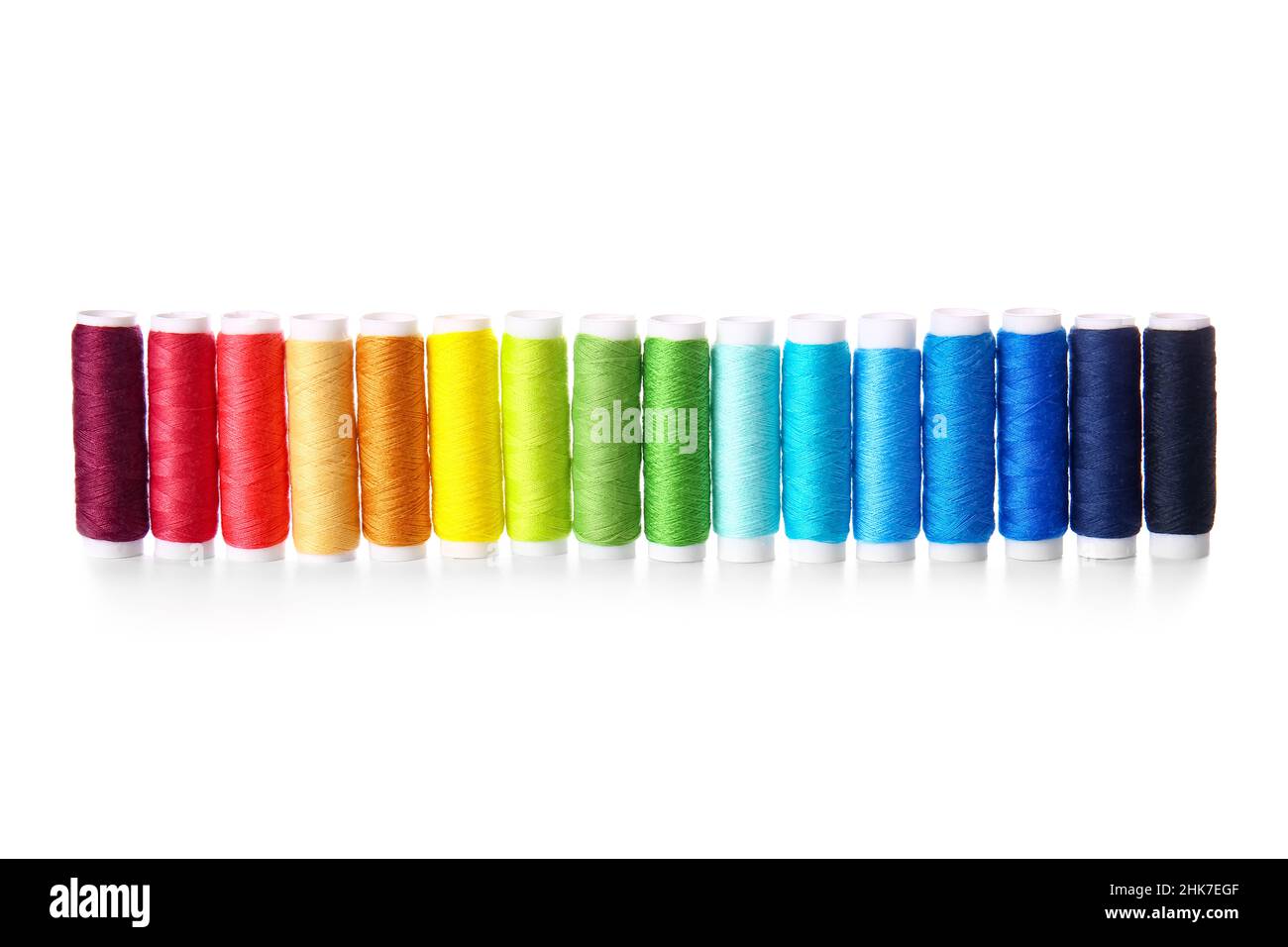 Colorful thread spools on white background Stock Photo - Alamy