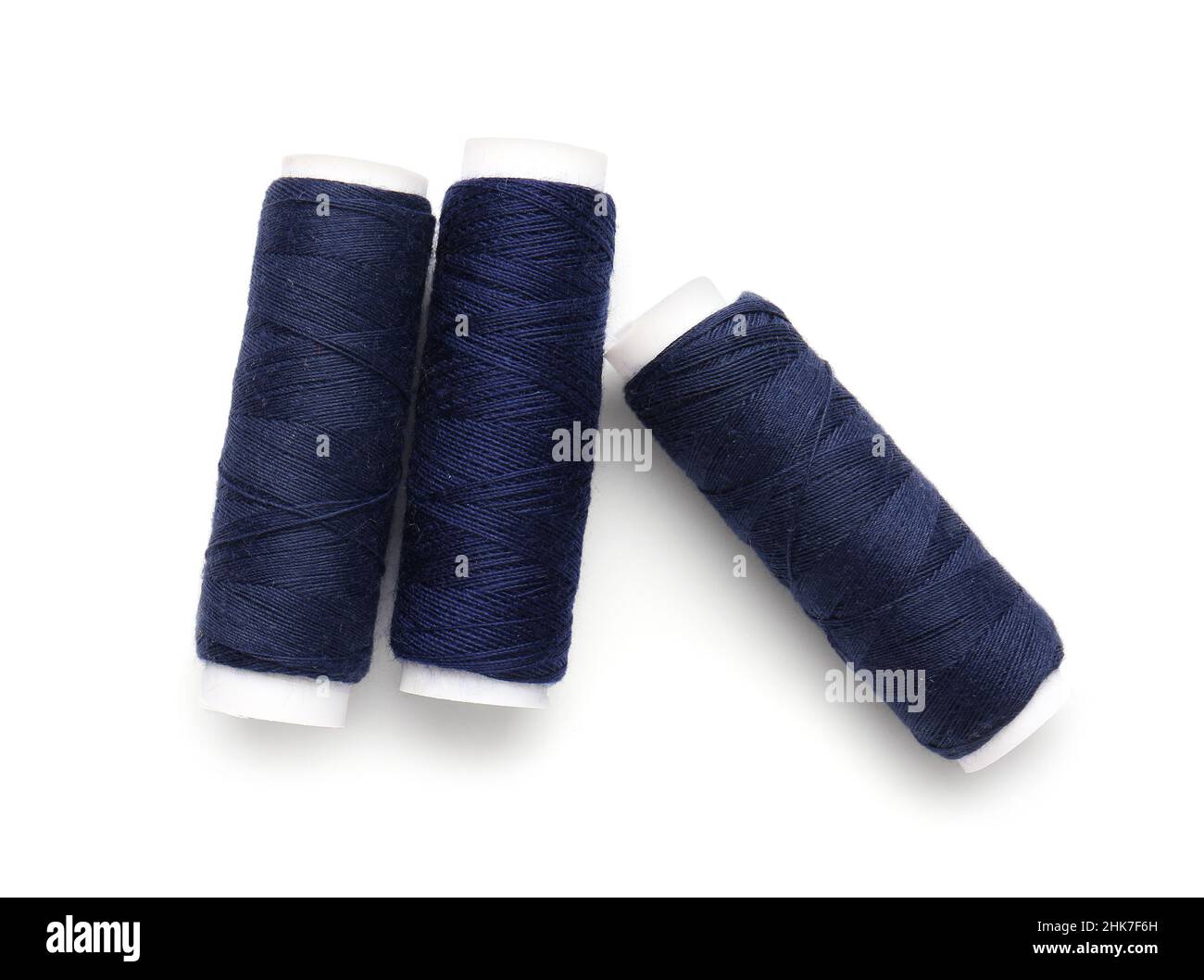 Blue thread spools on white background Stock Photo - Alamy