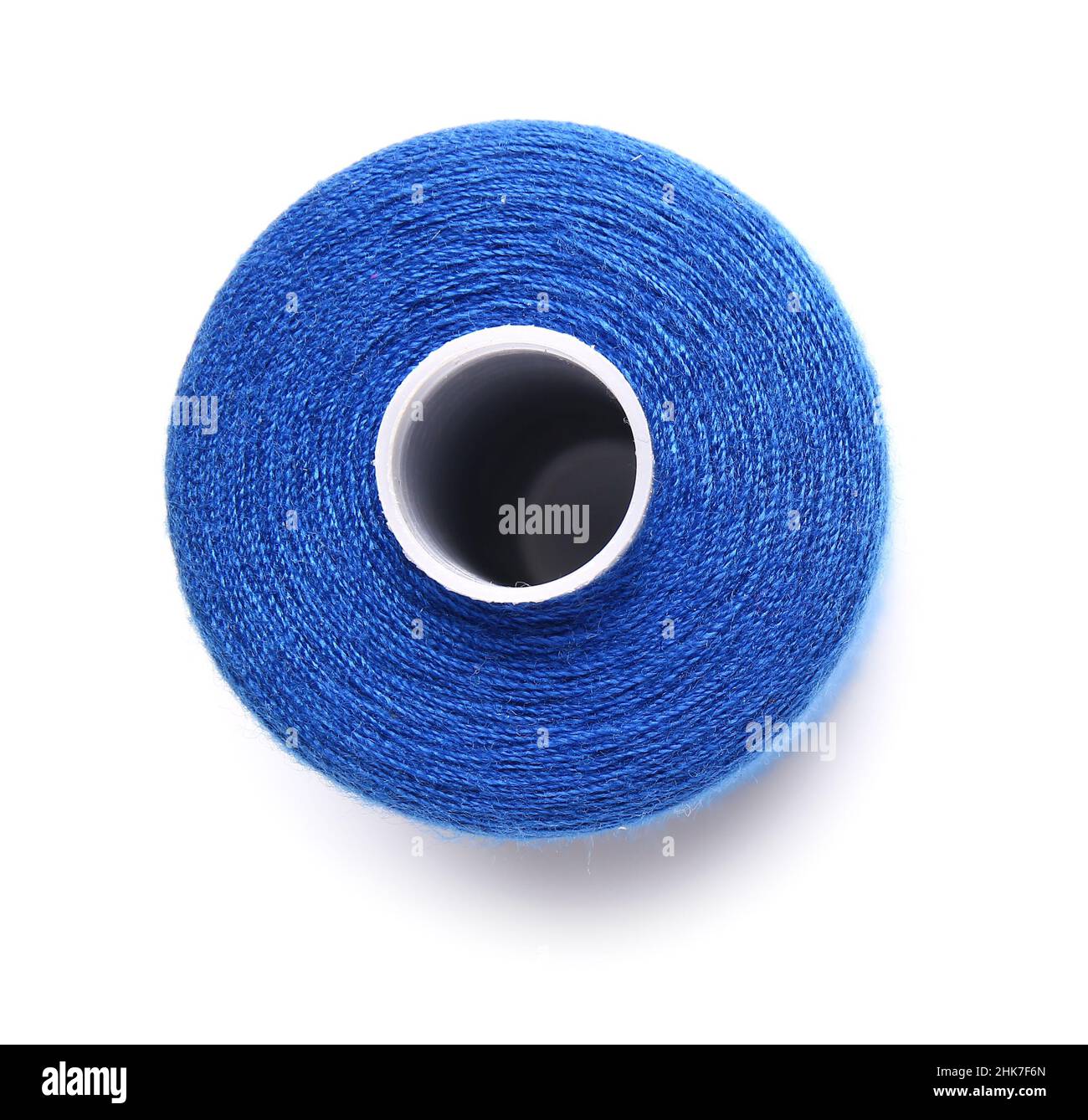 Blue thread spool on white background Stock Photo - Alamy