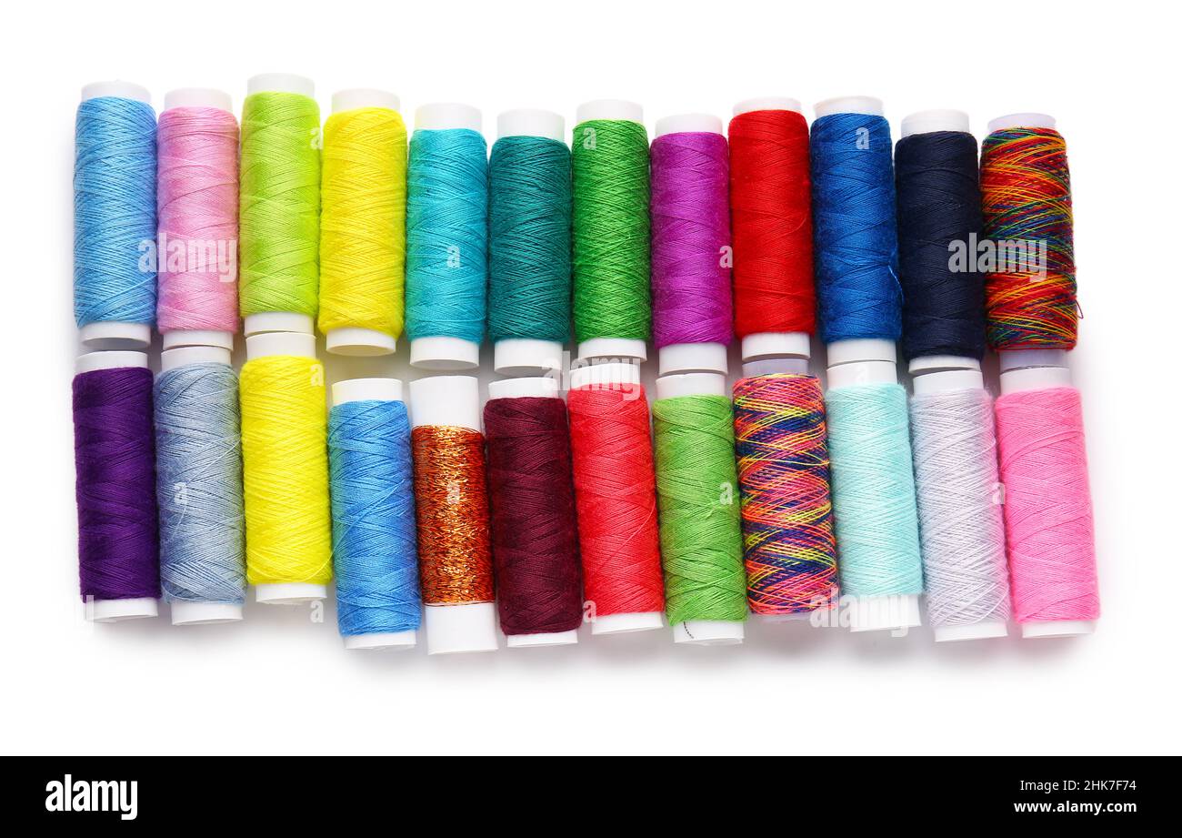 Different thread spools on white background Stock Photo - Alamy