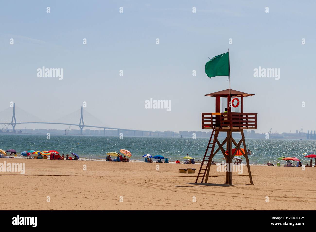 lifeguard keeping watch from the valdelagrana, cadiz beach watchtower ...