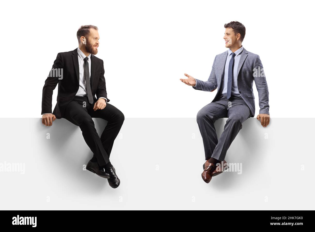 Young professional men sitting on a panel and having a conversation ...