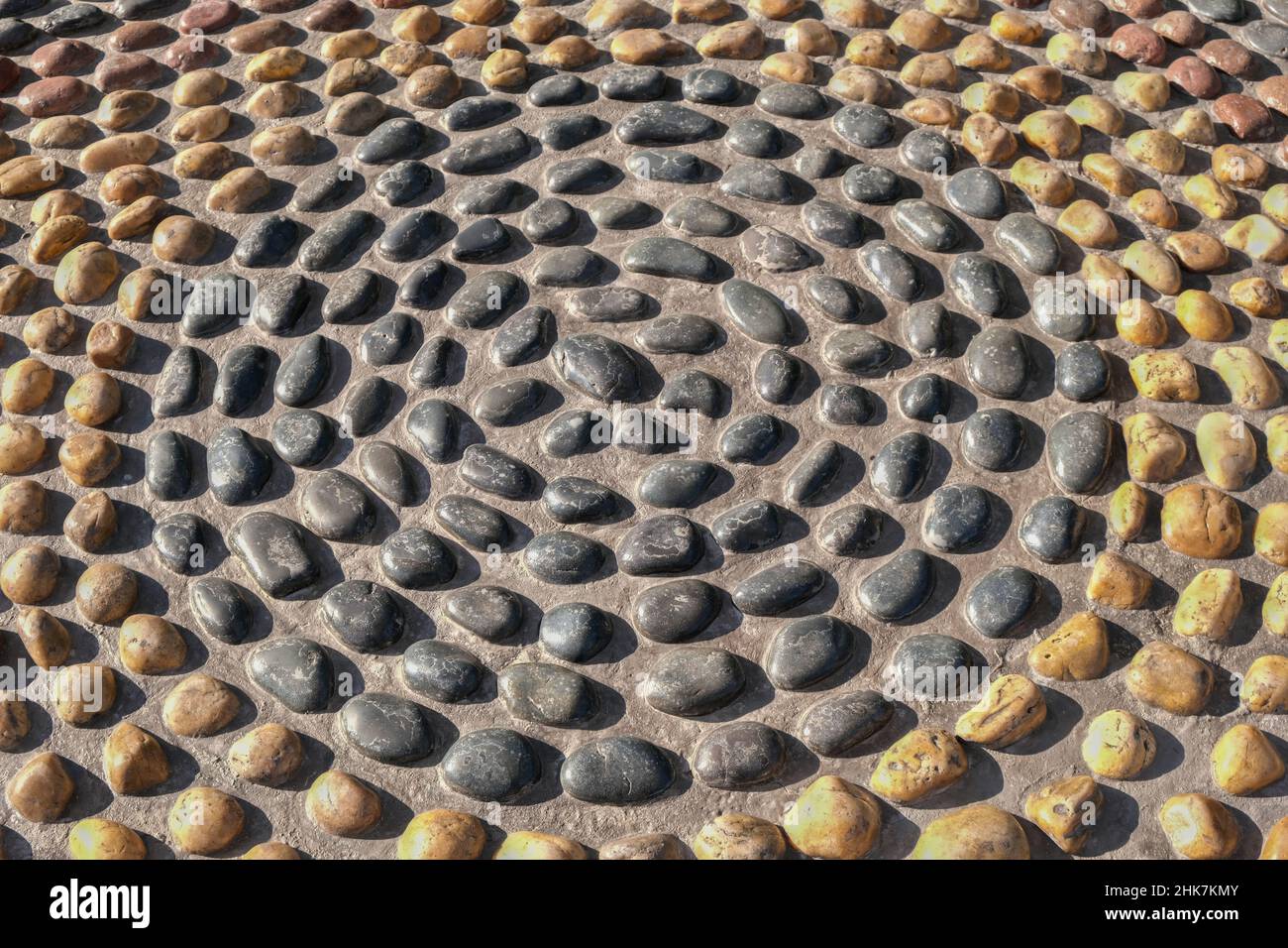 Mosaic circle pattern from convex rounded pebble stones. Ground path ...